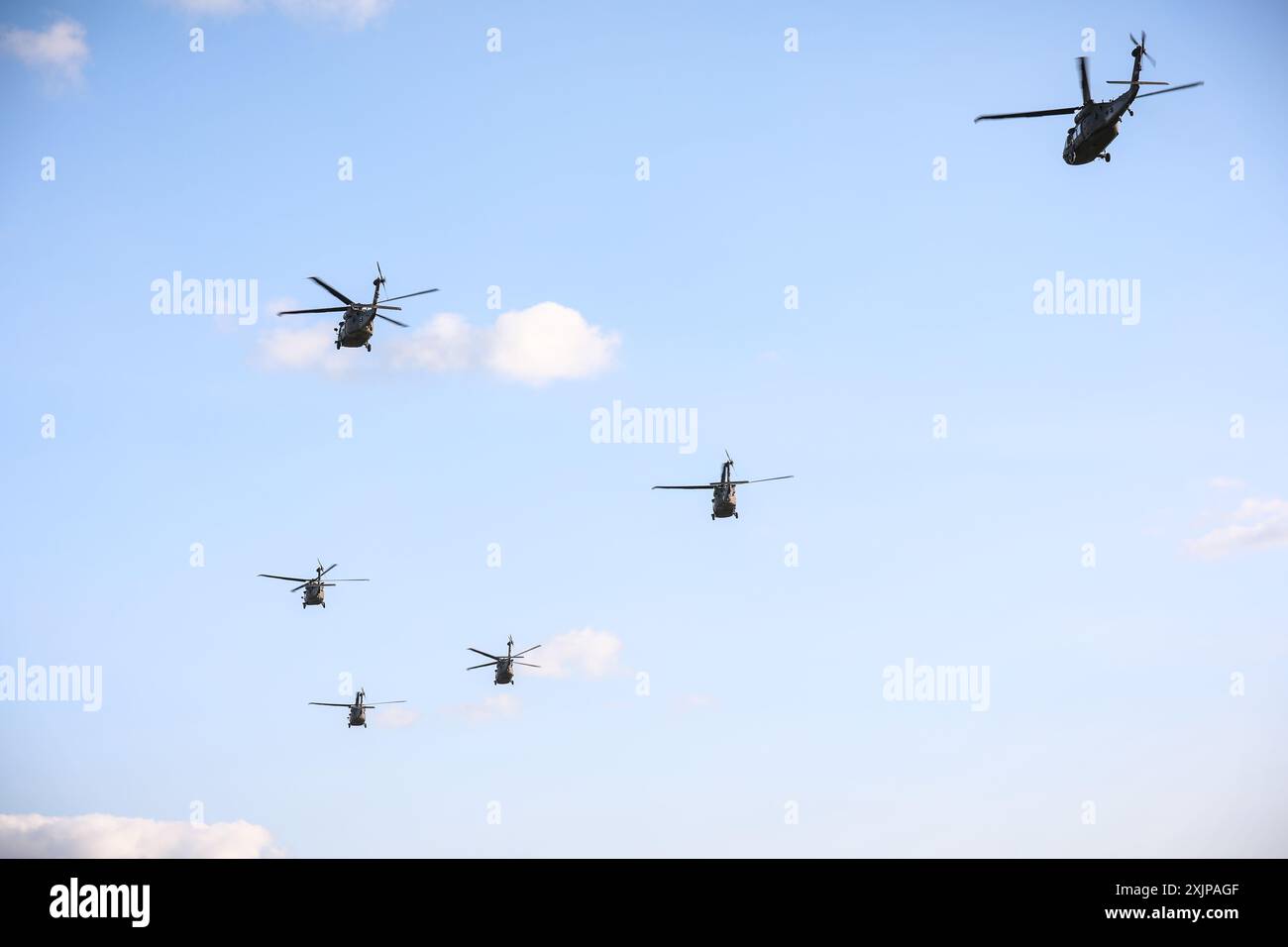 UH-60 Black Hawk helicopters fly in formation after picking up infantry ...