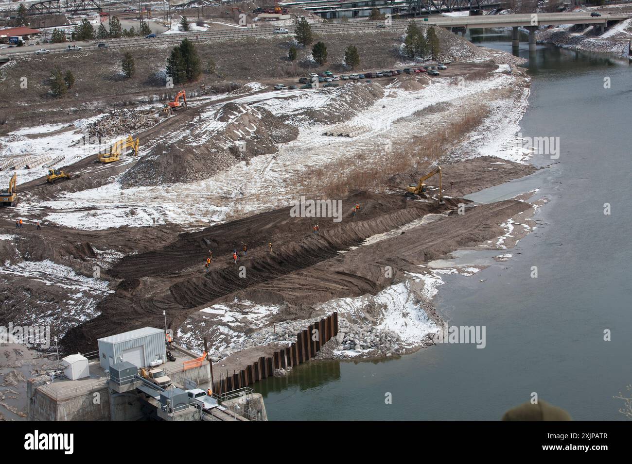 Backhoe breaches coffer dam and water starts draining. The clean fill ...