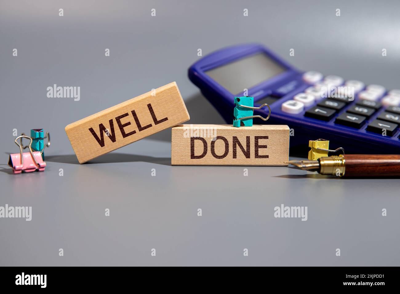 Well done symbol. Wooden blocks with words Well done. Beautiful grey ...