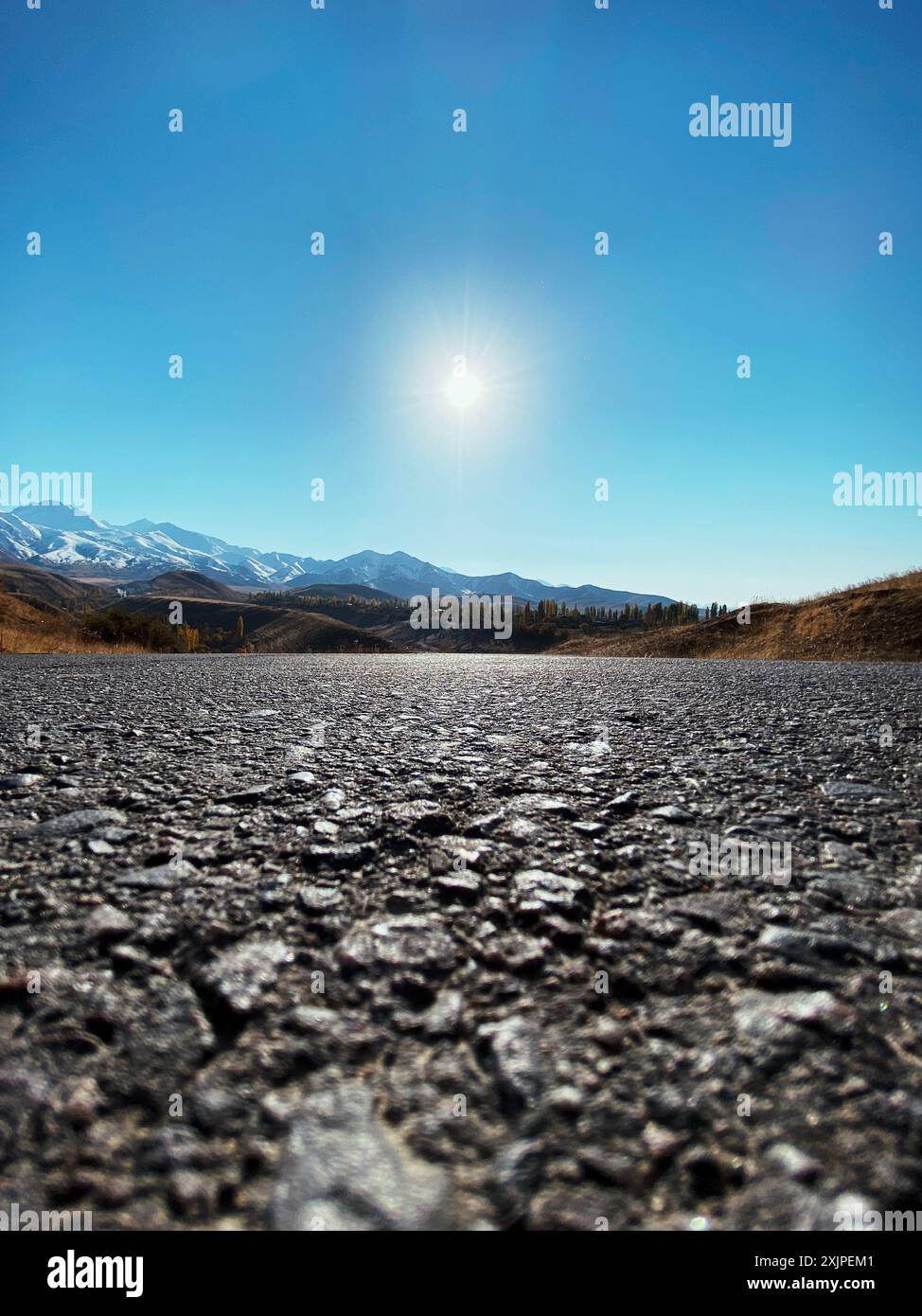 Enjoy a tranquil drive on an empty road with stunning mountain scenery ...