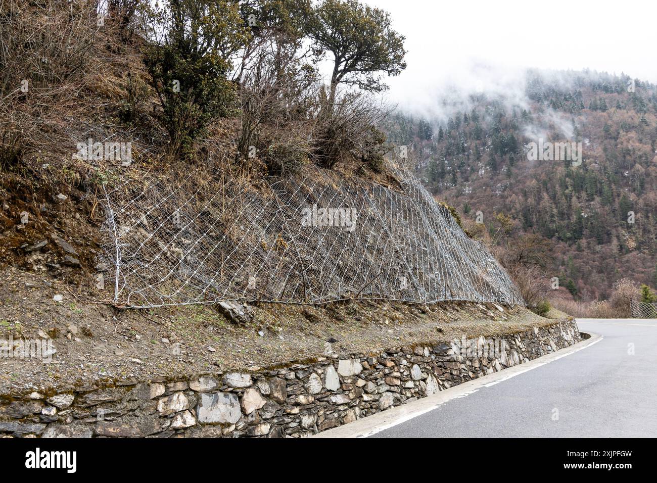 Wire mesh grid installed on slope to stabalize the soil and prevent ...