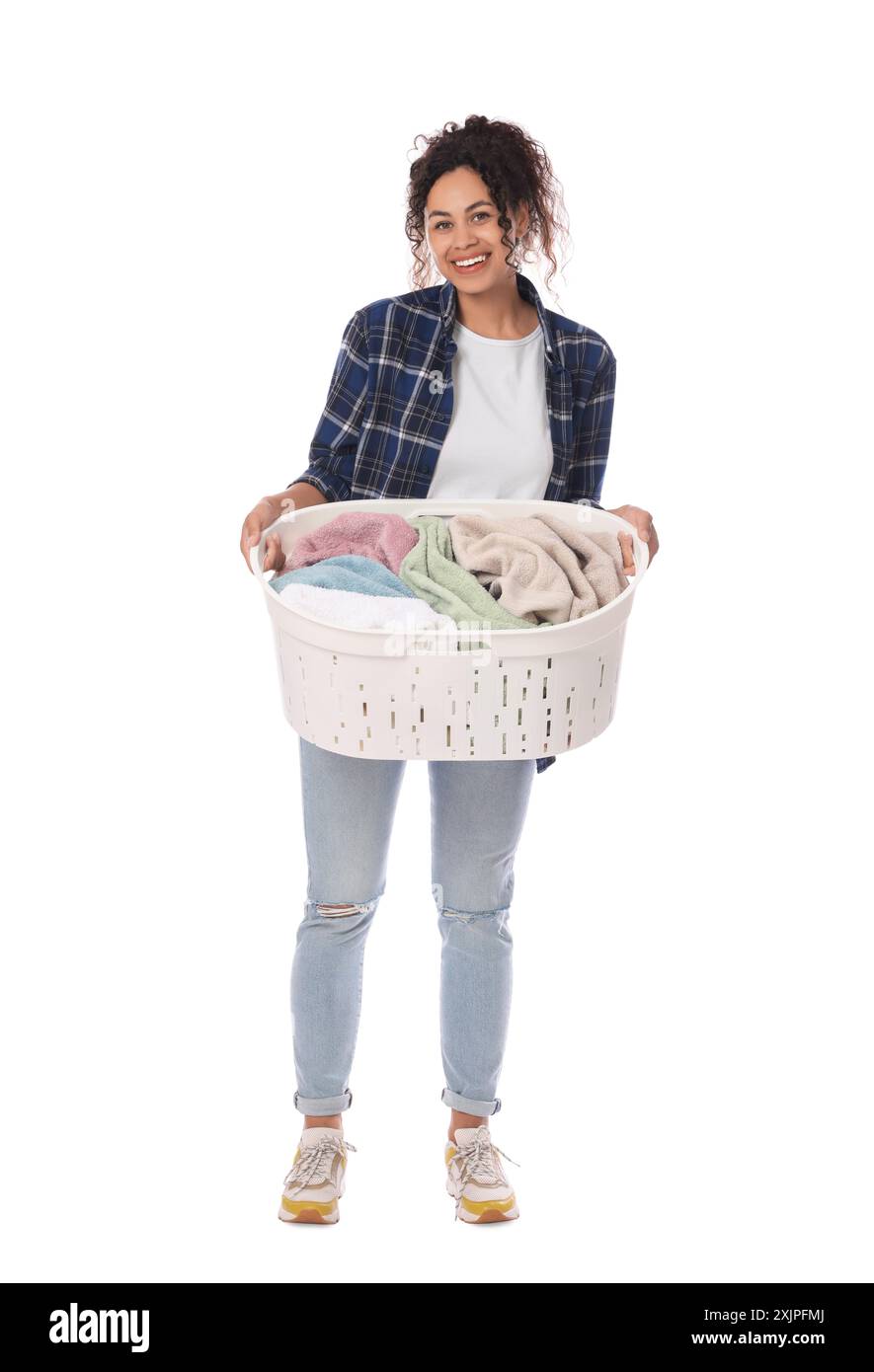 Happy woman with basket full of laundry on white background Stock Photo ...