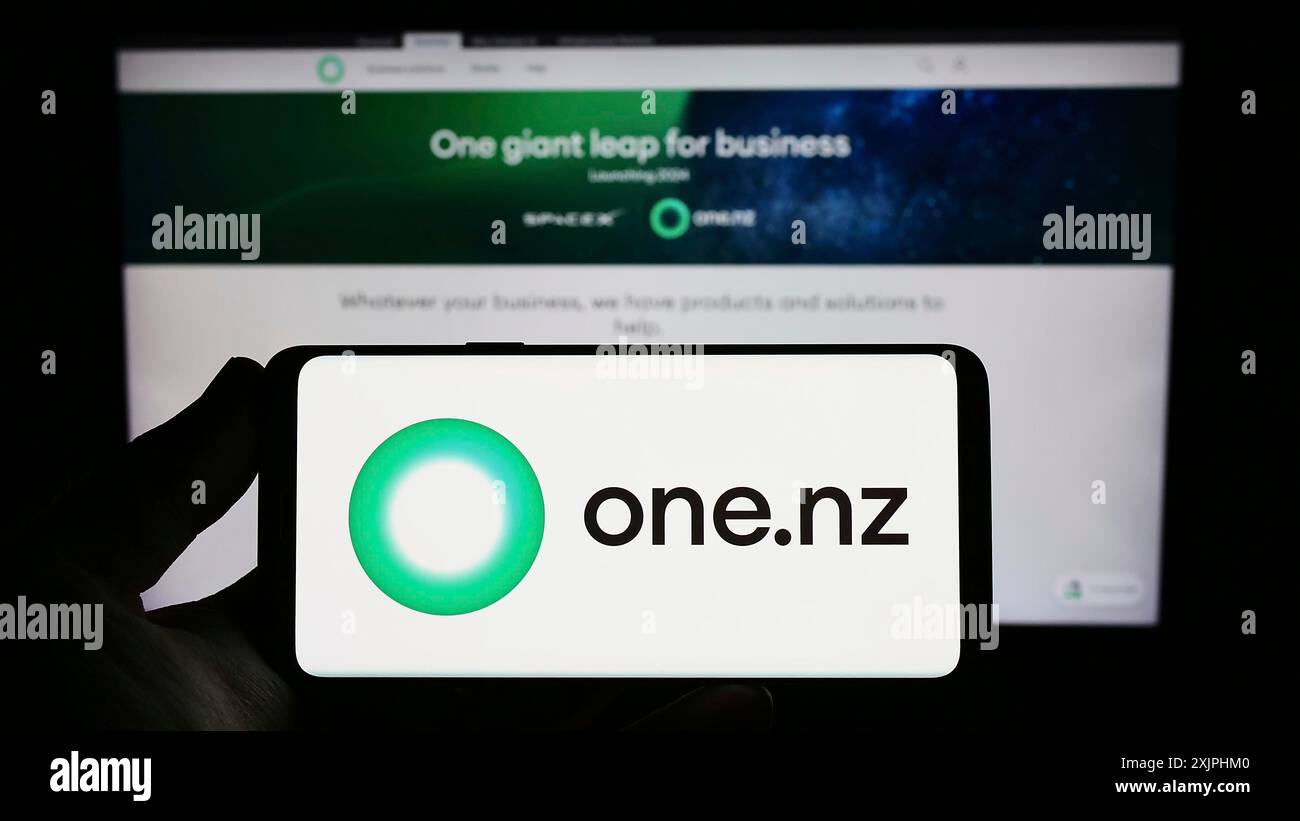 Stuttgart, Germany, 06-24-2023: Person holding smartphone with logo of company One New Zealand ...