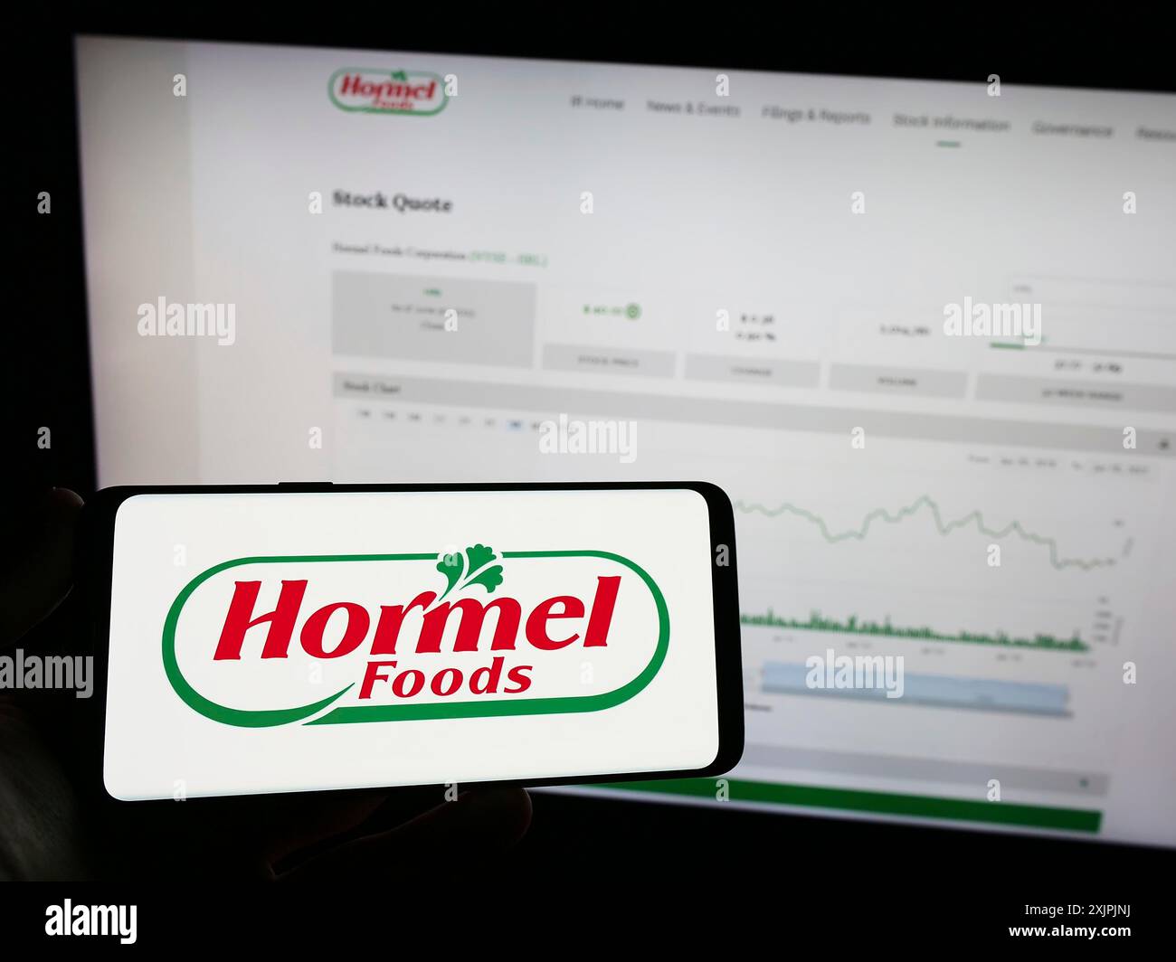 Stuttgart, Germany, 07-02-2023: Person holding mobile phone with logo of American food company ...