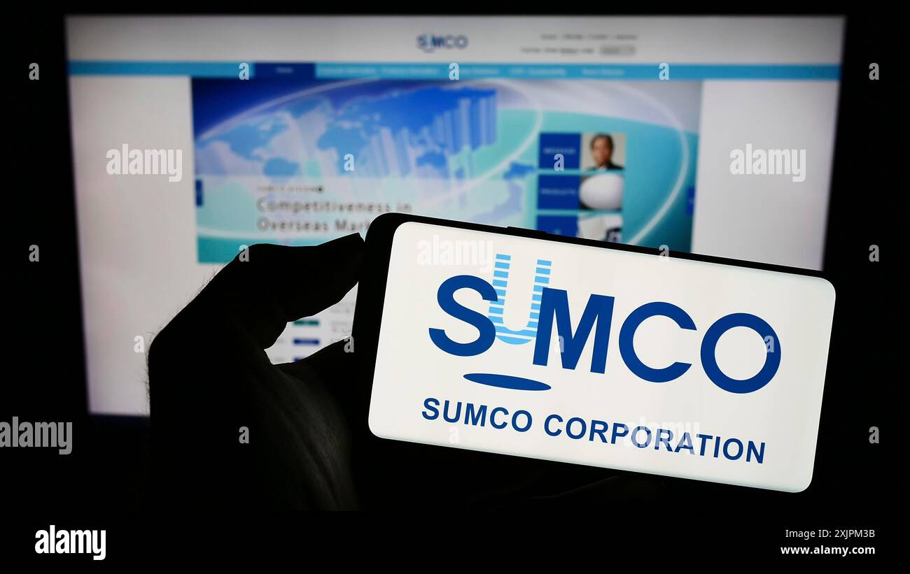 Stuttgart, Germany, 07-21-2023: Person holding cellphone with logo of Japanese semiconductor ...