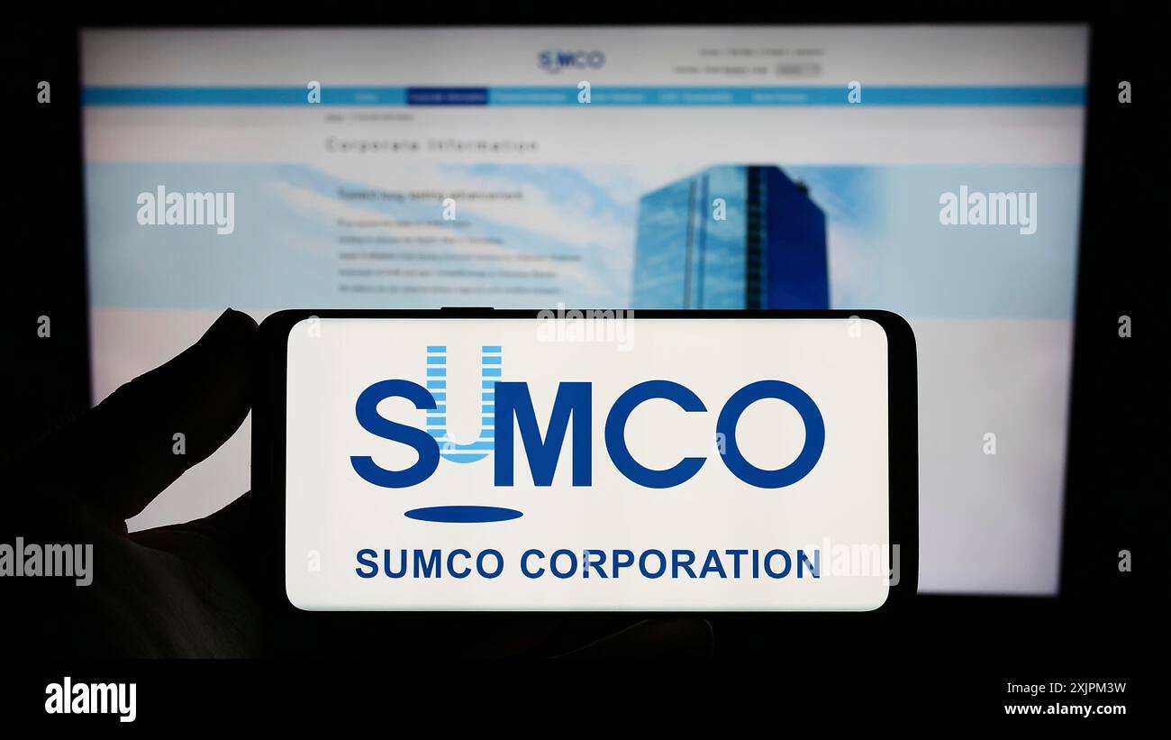 Stuttgart, Germany, 07-21-2023: Person holding smartphone with logo of Japanese semiconductor ...