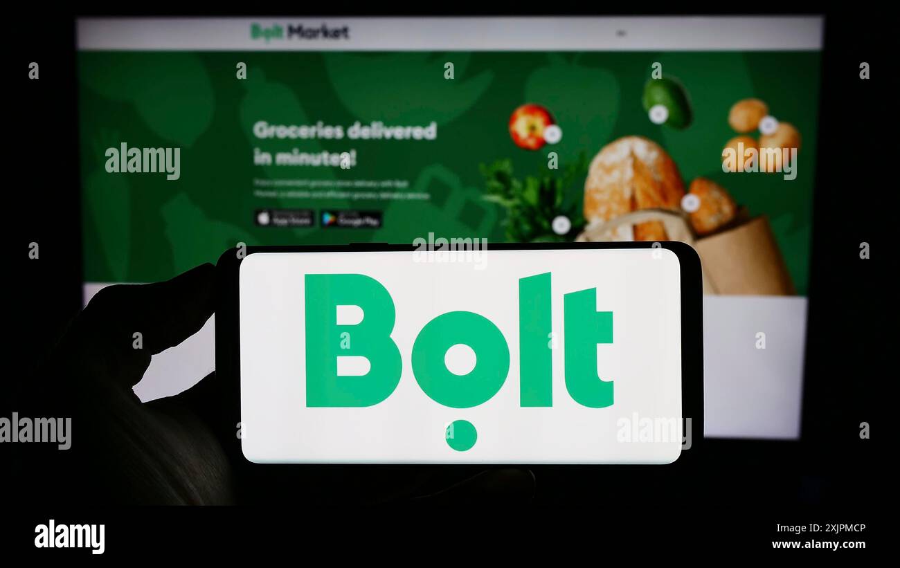 Stuttgart, Germany, 07-26-2023: Person holding cellphone with logo of Estonian mobility company ...