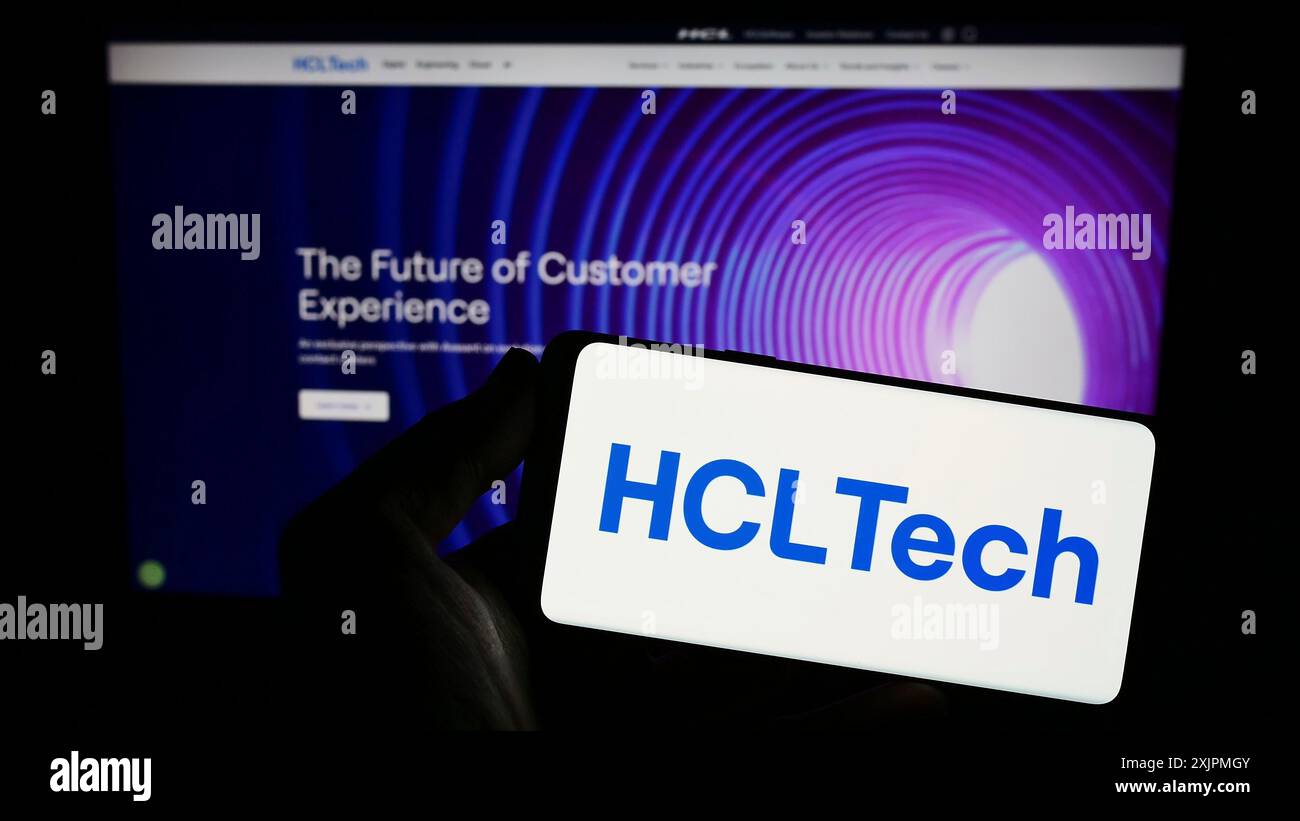 Stuttgart, Germany, 07-28-2023: Person holding smartphone with logo of Indian company HCL ...