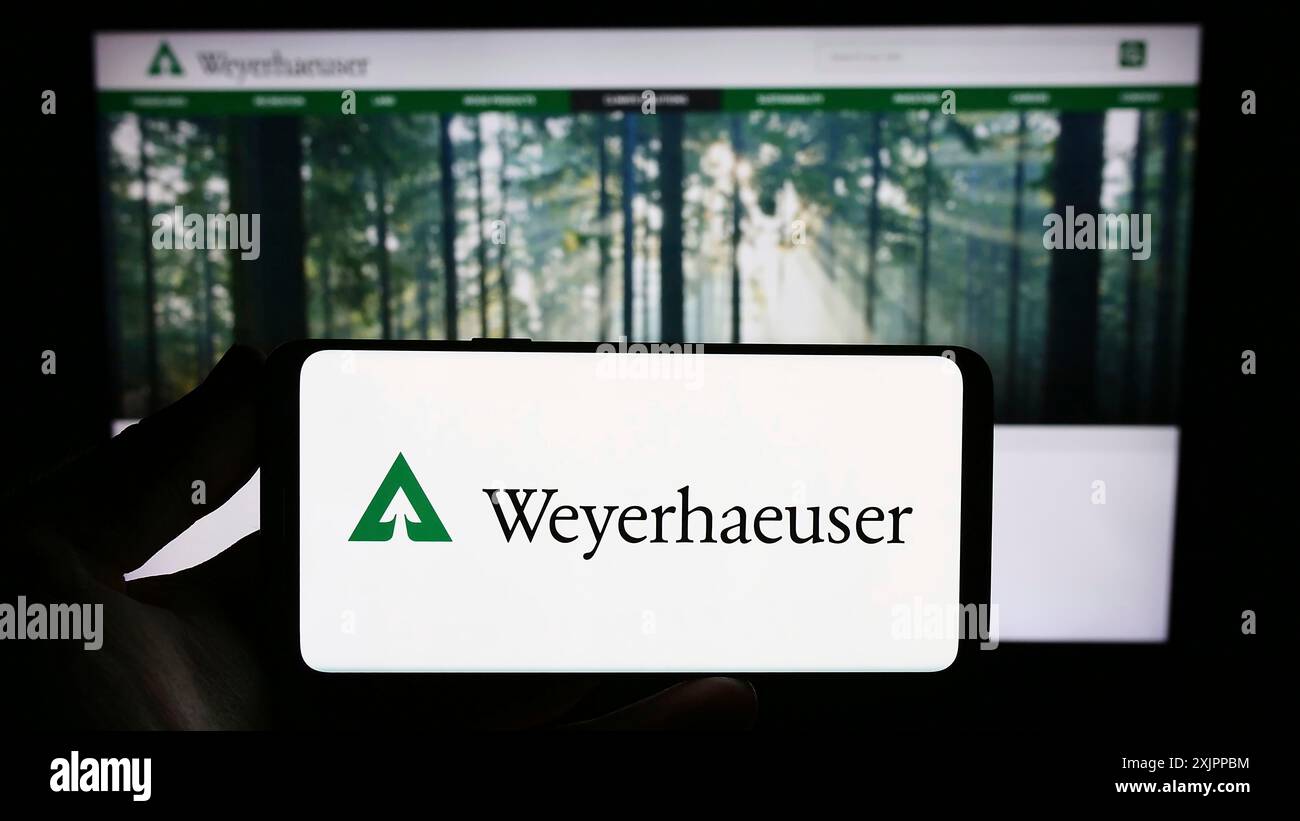 Stuttgart, Germany, 08-12-2023: Person holding smartphone with logo of ...