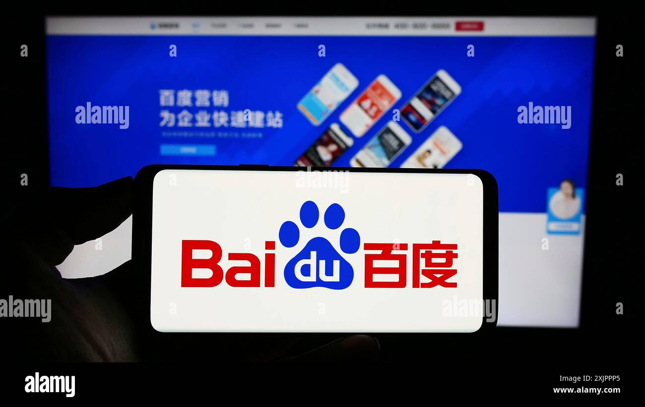 Stuttgart, Germany, 08-15-2023: Person holding cellphone with logo of Chinese technology company ...