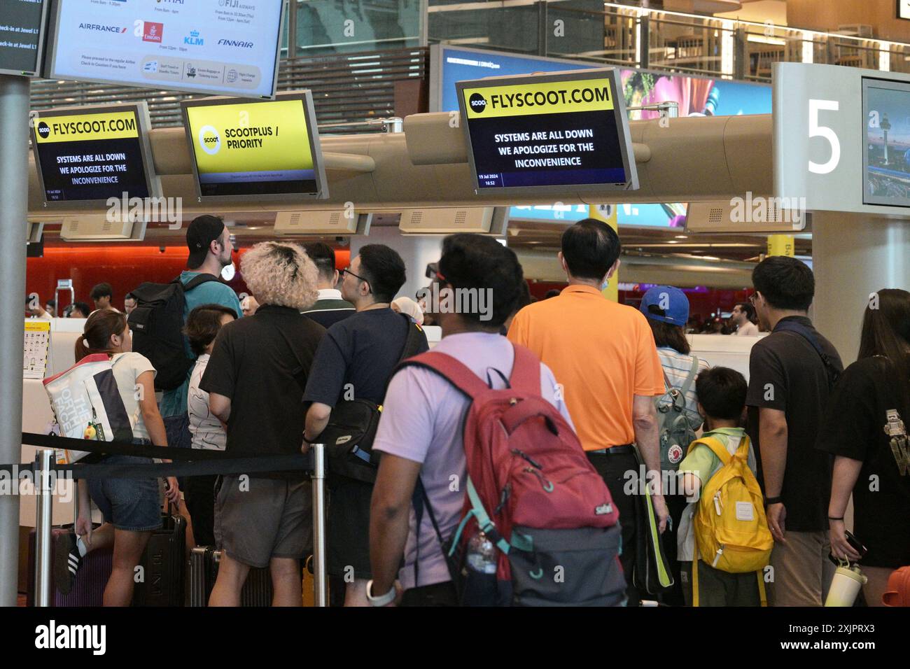 Beijing, China. 19th July, 2024. Long queues of passengers are seen in ...