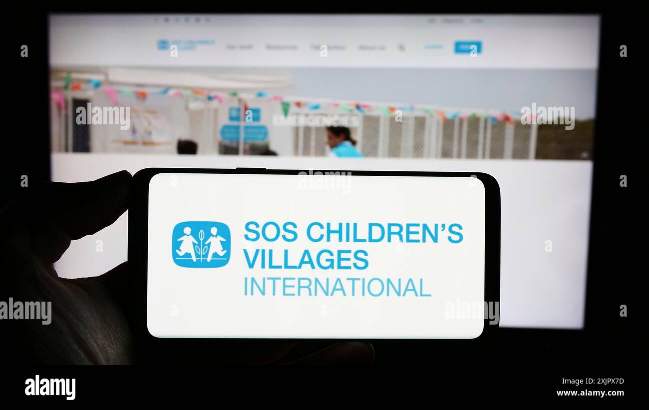 Stuttgart, Germany, 10-06-2023: Person holding mobile phone with logo ...