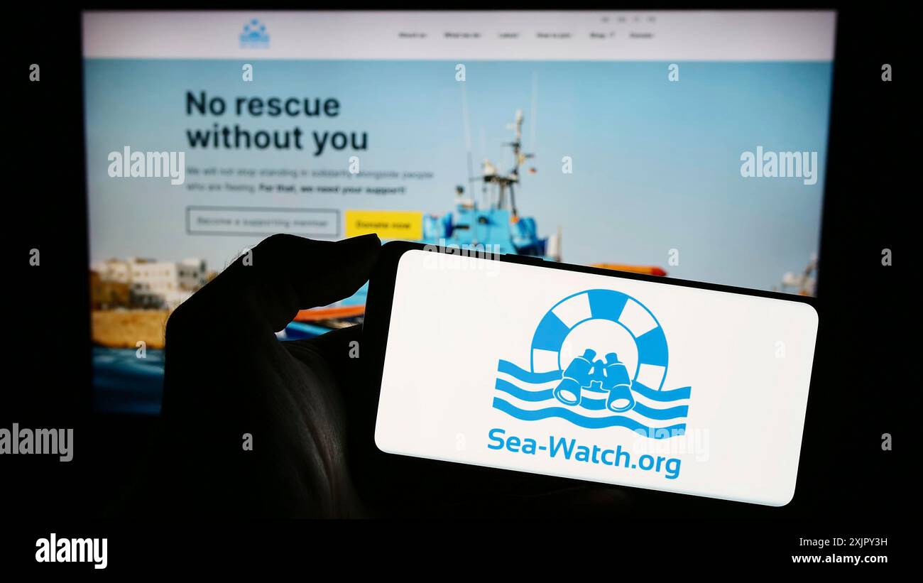 Stuttgart, Germany, 10-25-2023: Person holding mobile phone with logo of German association Sea ...