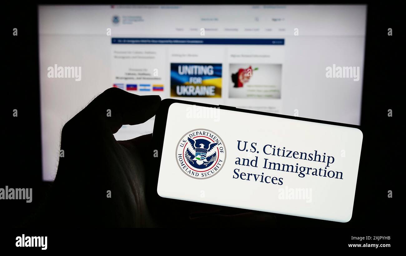 Stuttgart, Germany, 10-29-2023: Person holding cellphone with seal of ...