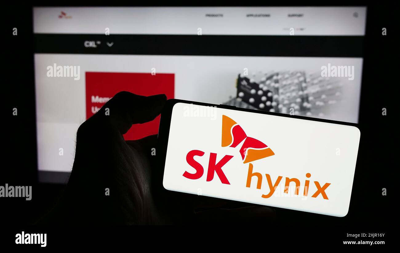 Stuttgart, Germany, 11-16-2023: Person holding cellphone with logo of South Korean semiconductor ...