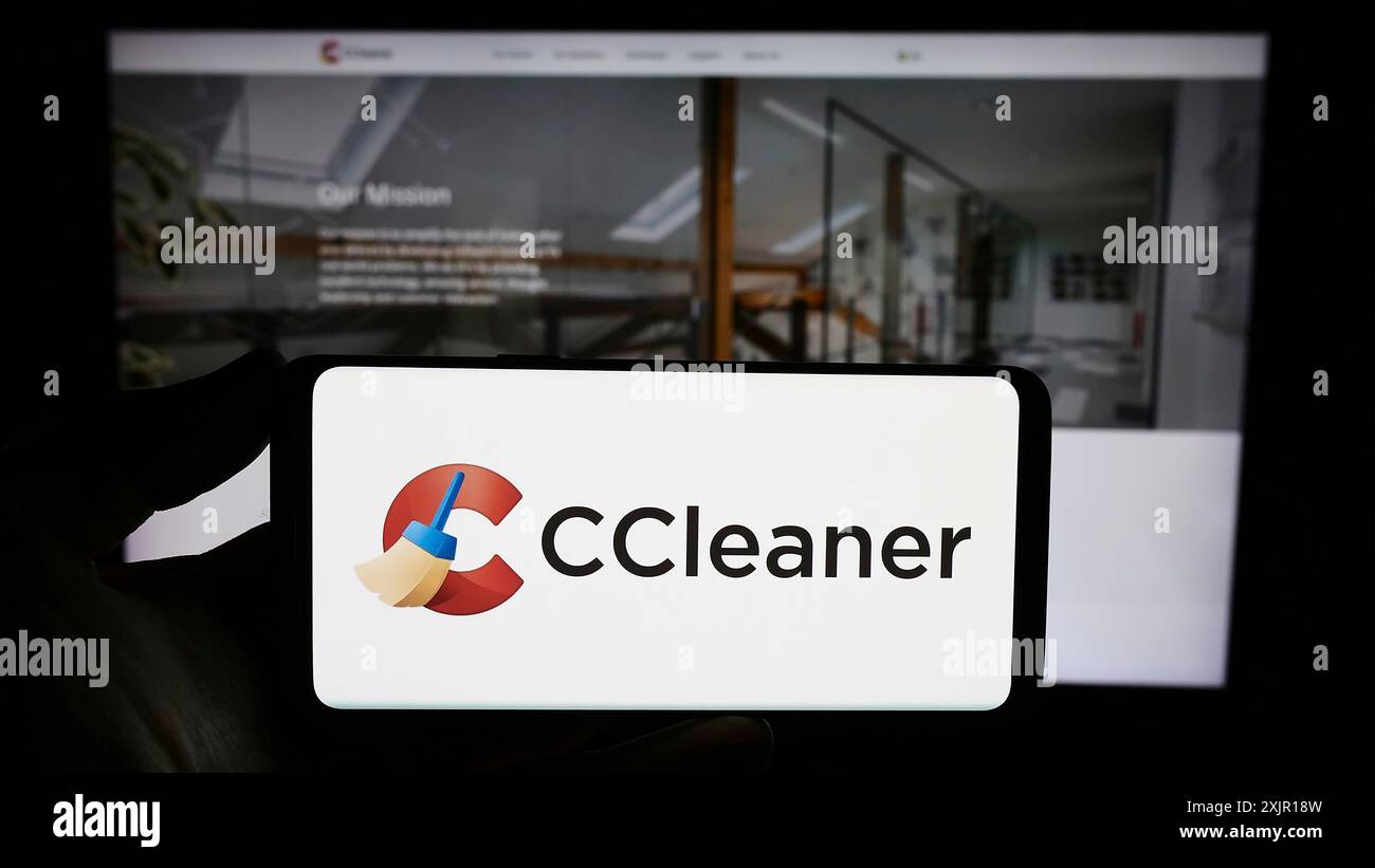 Stuttgart, Germany, 11-15-2023: Person holding smartphone with logo of computer system clearning ...