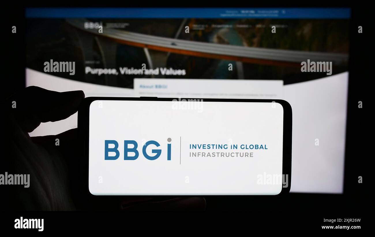 Stuttgart, Germany, 12-02-2023: Person holding cellphone with logo of investment company BBGI ...