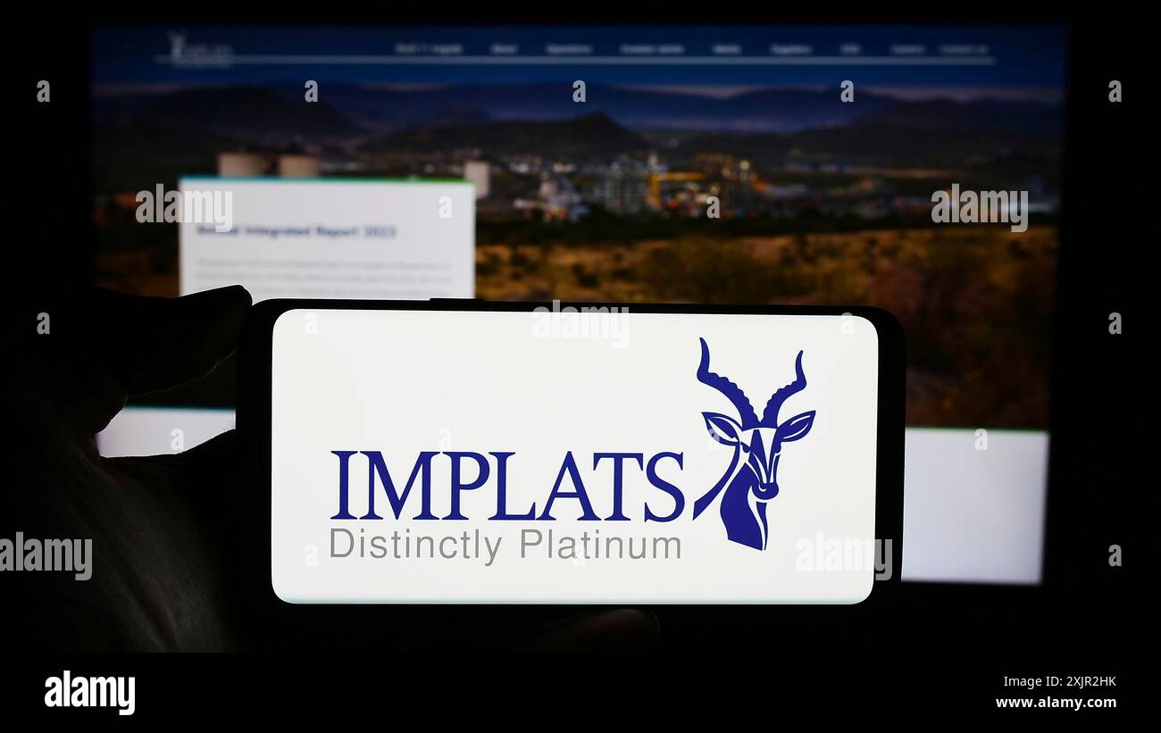 Stuttgart, Germany, 12-07-2023: Person holding cellphone with logo of company Impala Platinum ...