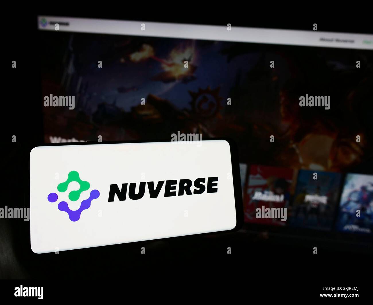 Stuttgart, Germany, 12-07-2023: Person holding cellphone with logo of video game company Nuverse ...