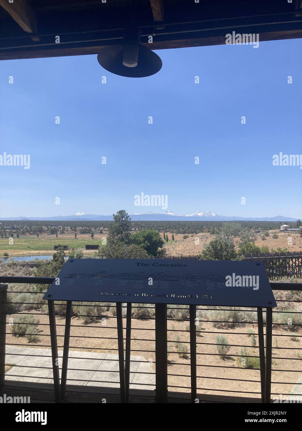 View over a wooden trestle bridge towards the Cascades from a ...