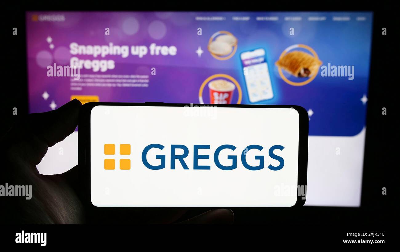 Stuttgart, Germany, 12-14-2023: Person holding cellphone with logo of ...