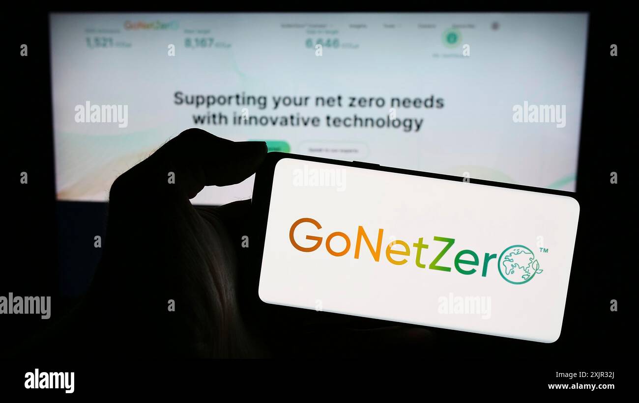 Stuttgart, Germany, 12-14-2023: Person holding cellphone with logo of ...