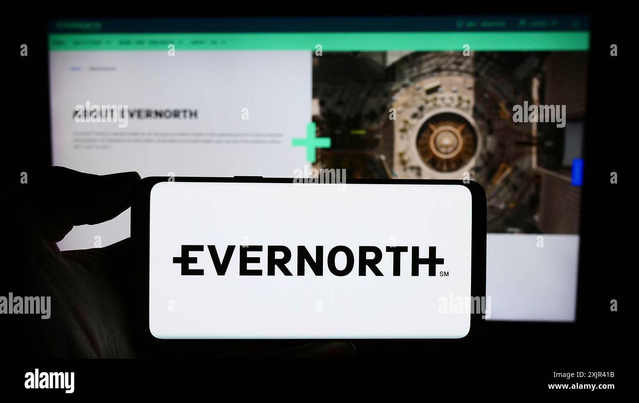 Stuttgart, Germany, 12-31-2023: Person holding mobile phone with logo ...