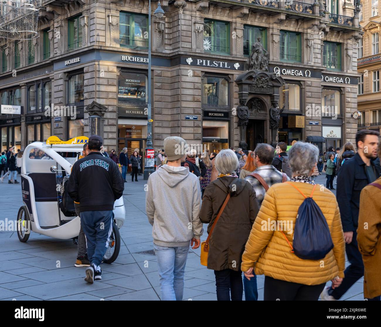 Wien, Austria - October 28, 2023 : People walk past ornate storefronts ...