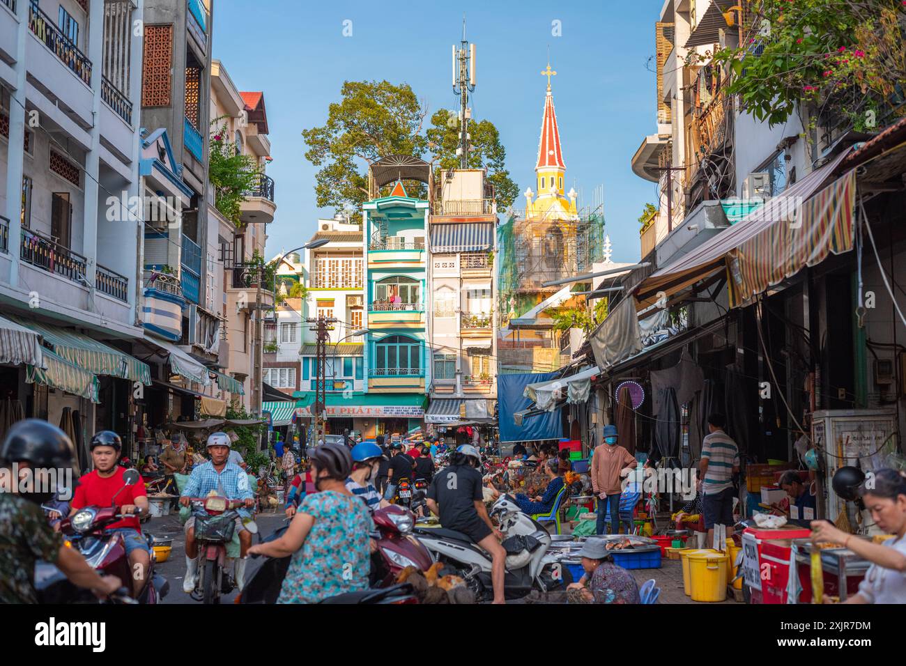 Ho Chi Minh City, Vietnam - May 25, 2024: a busy market street with a ...