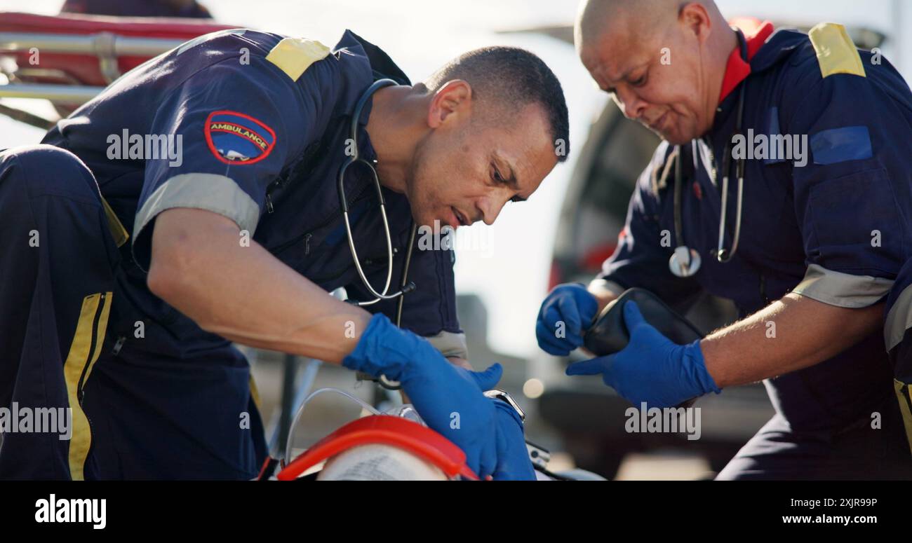 Paramedic, emergency and men with accident in road for first aid ...