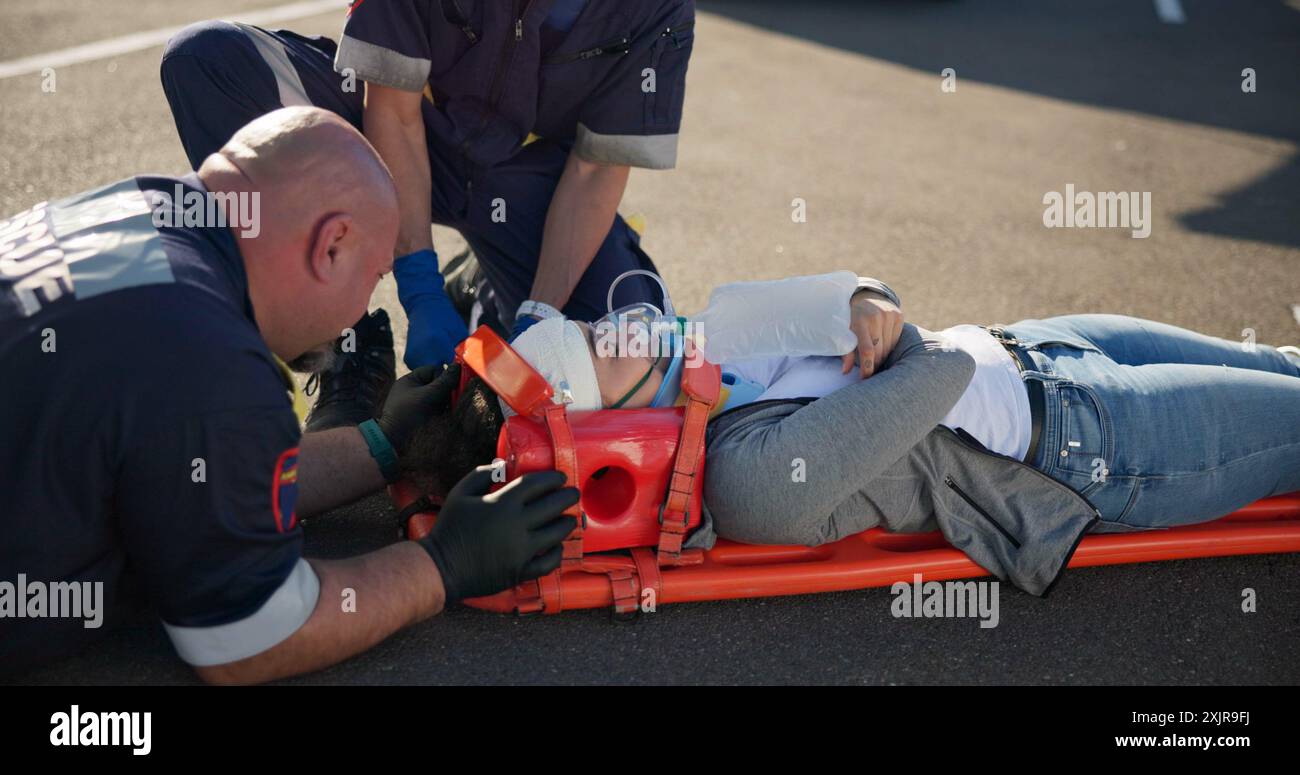 Outdoor, emergency and patient with paramedics, healthcare and rescue ...