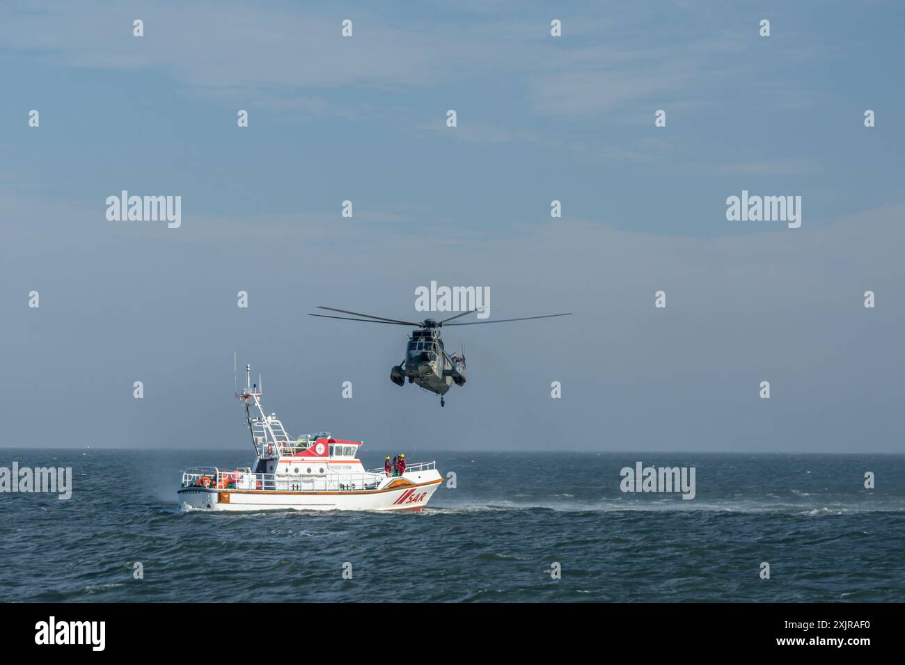 SAR rescue cruiser in the North Sea with a German Navy helicopter ...