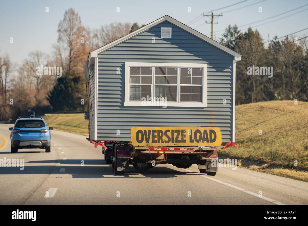 Oversize load home. Manufactured house transported on the highway ...