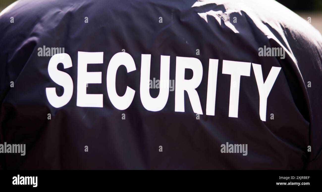 Corporate security team standing in formation, hands clasped ...