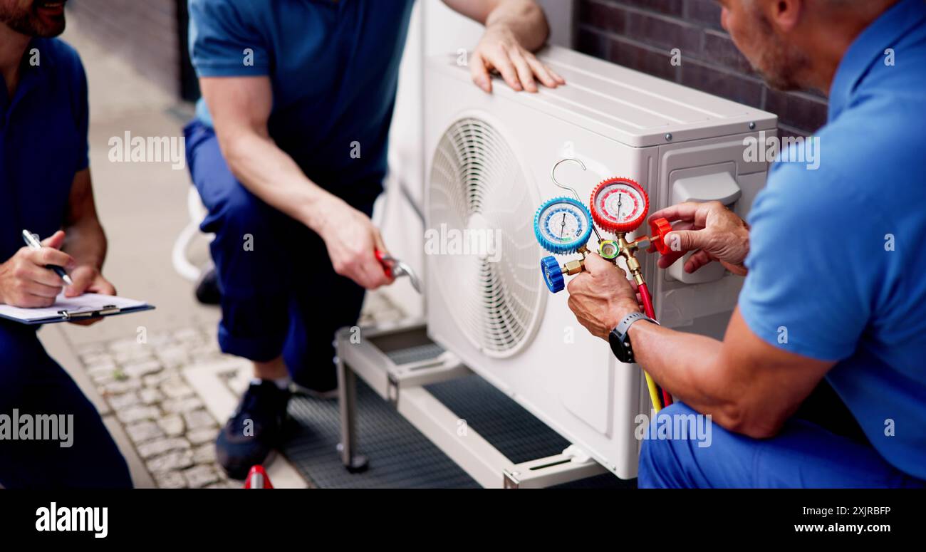 Experienced HVAC technician inspecting commercial building for air ...