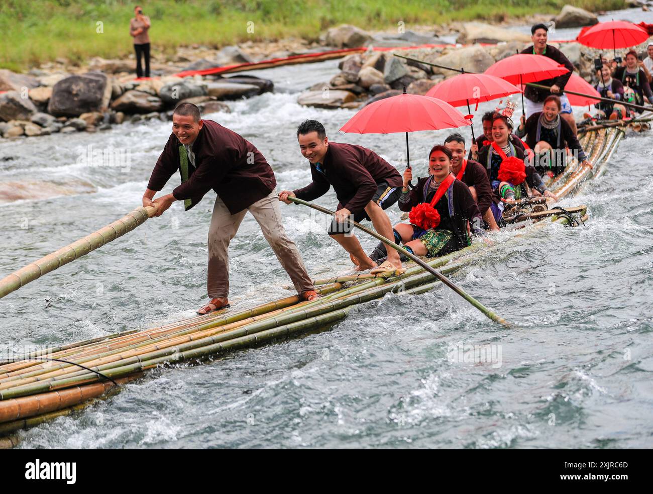Zhuang ethnic group members are taking part in bamboo rafting during ...