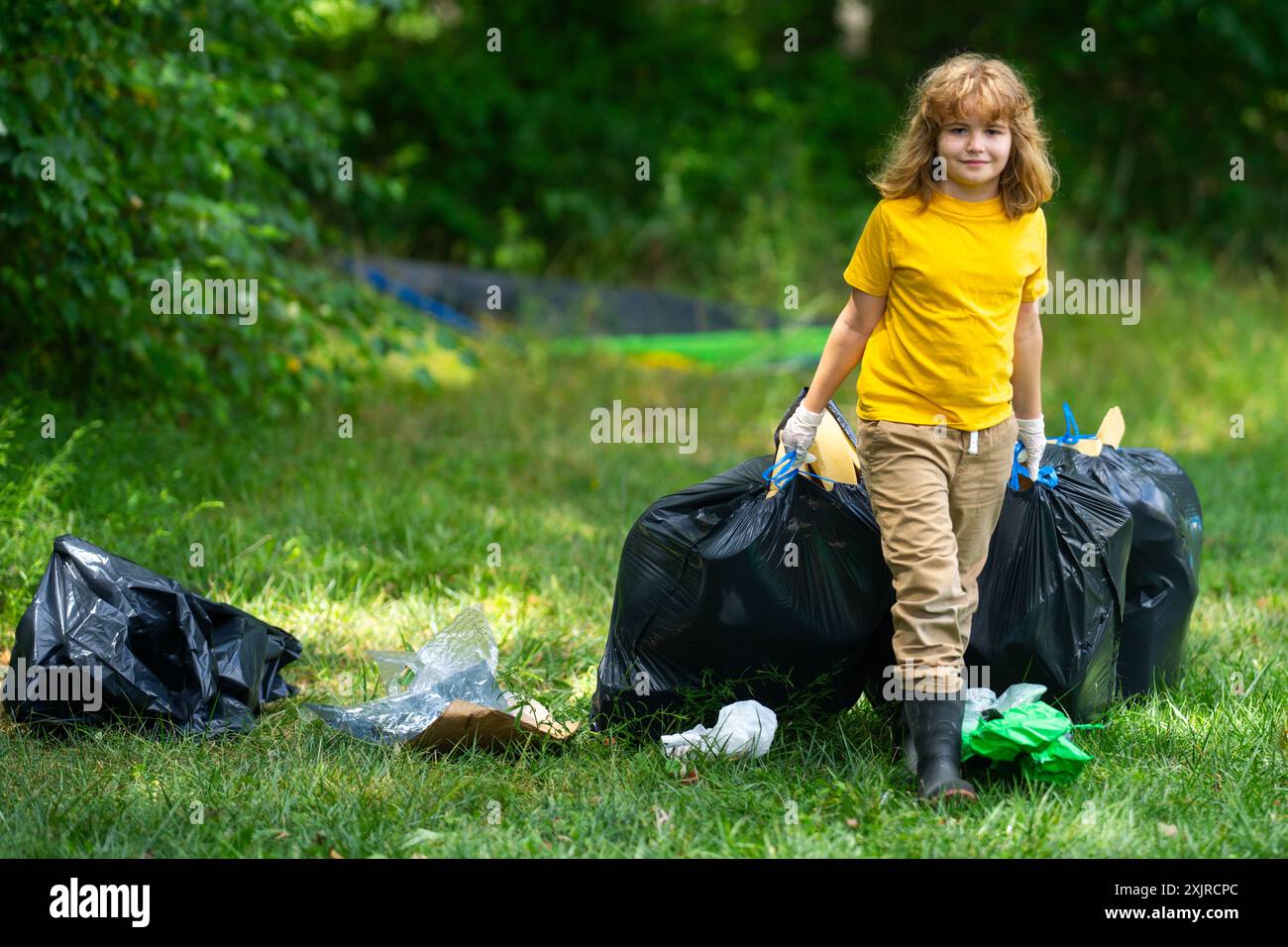 Environment plastic pollution. Volunteer child collecting trash in the ...
