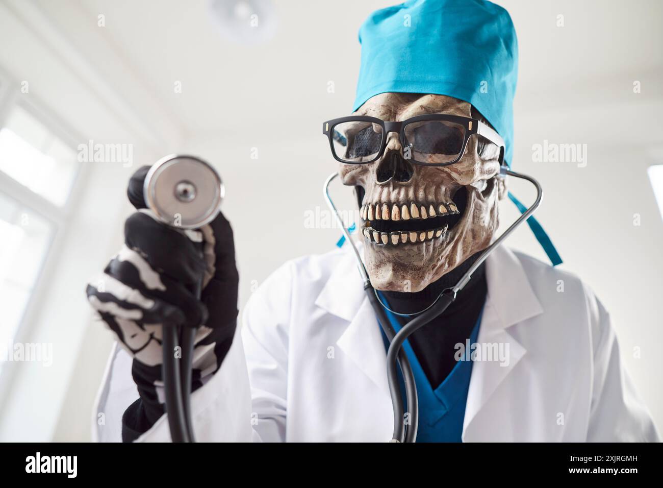 Doctor wearing scull skeleton mask in white medical uniform standing ...