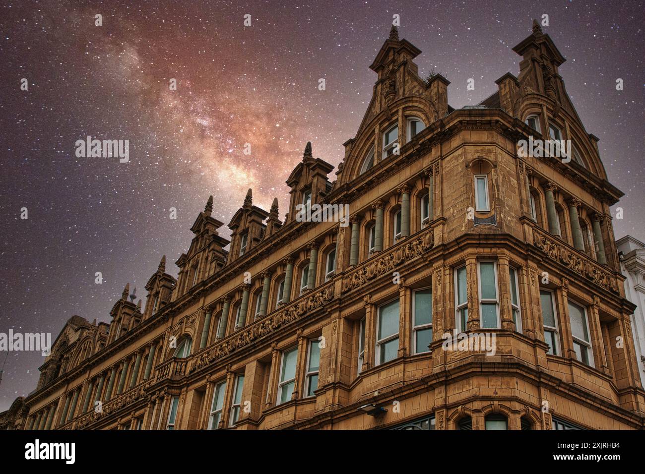 A historic building with ornate architecture under a starry night sky ...
