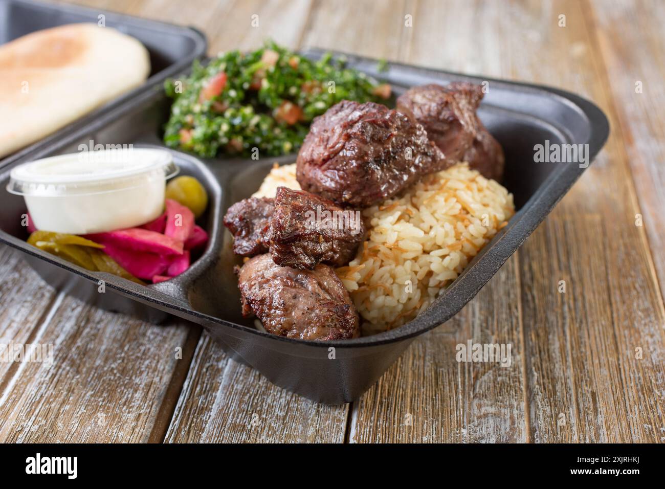 A view of a beef kabob combo in a styrofoam to-go container Stock Photo ...