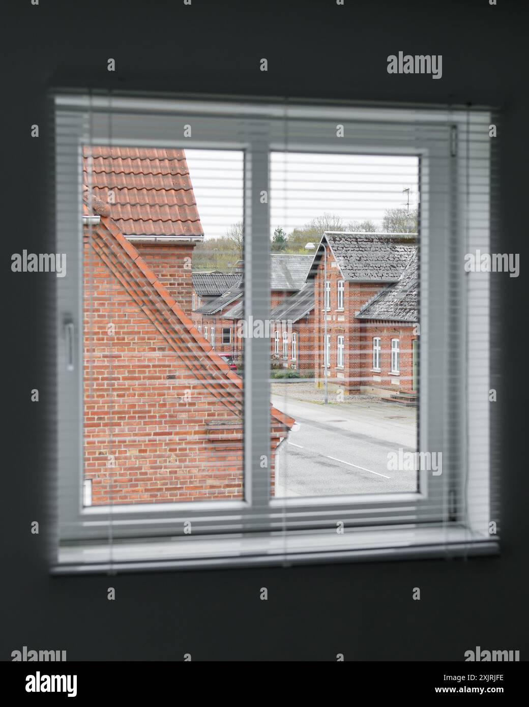 Home interior. View from the window through the blinds to the street ...