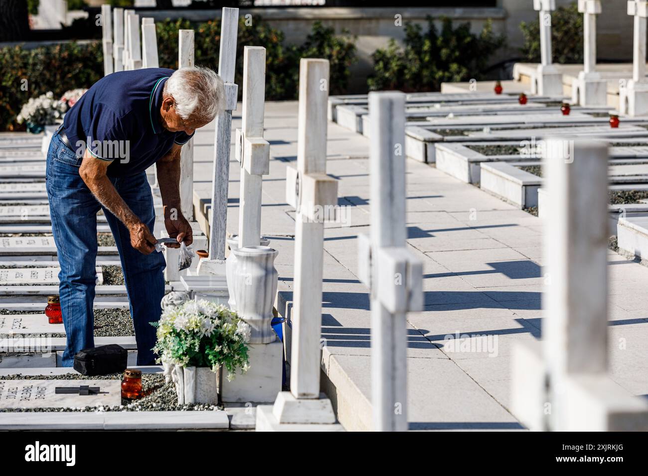 Nicosia, Cyprus. 20th July, 2024. A man is seen between the graves ...