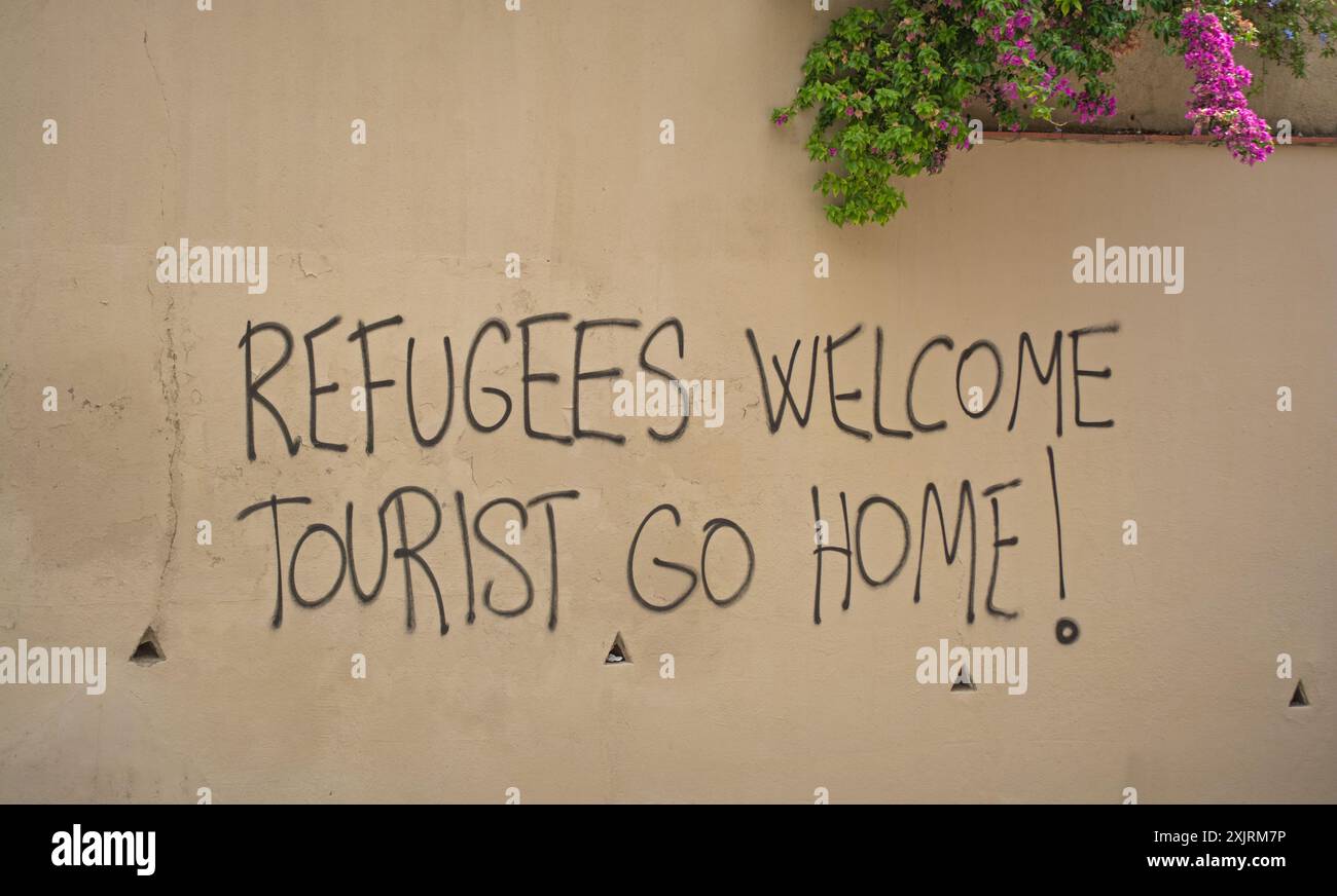 Barcelona, Spain. Graffiti on a wall that reads "Refugees welcome ...