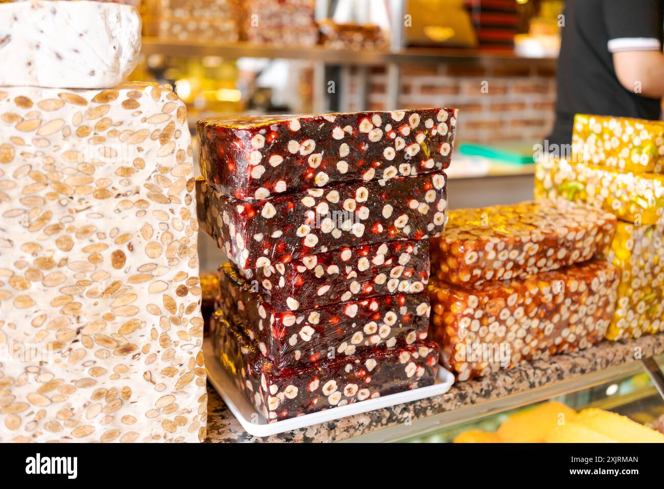 Assorted nougat bars with nuts and fruits neatly stacked on a shop ...