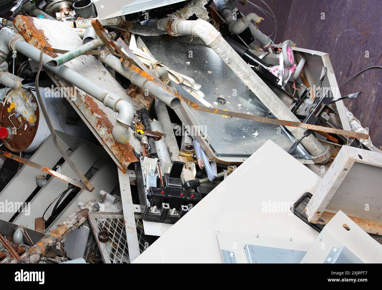 Scrap metal and twisted sheets in a recycling center container to save ...