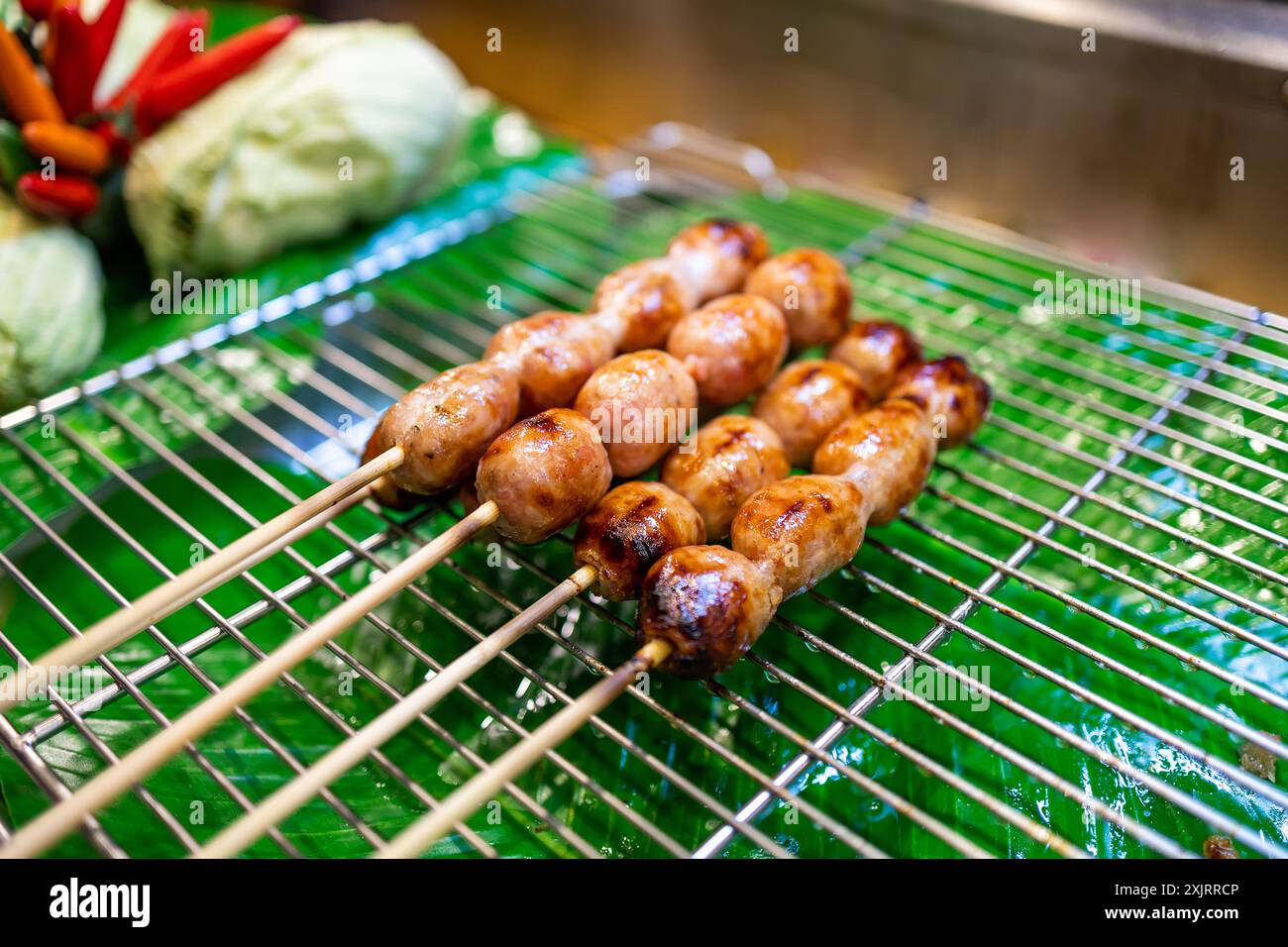 Isan Sausage on banana leaf Stock Photo - Alamy
