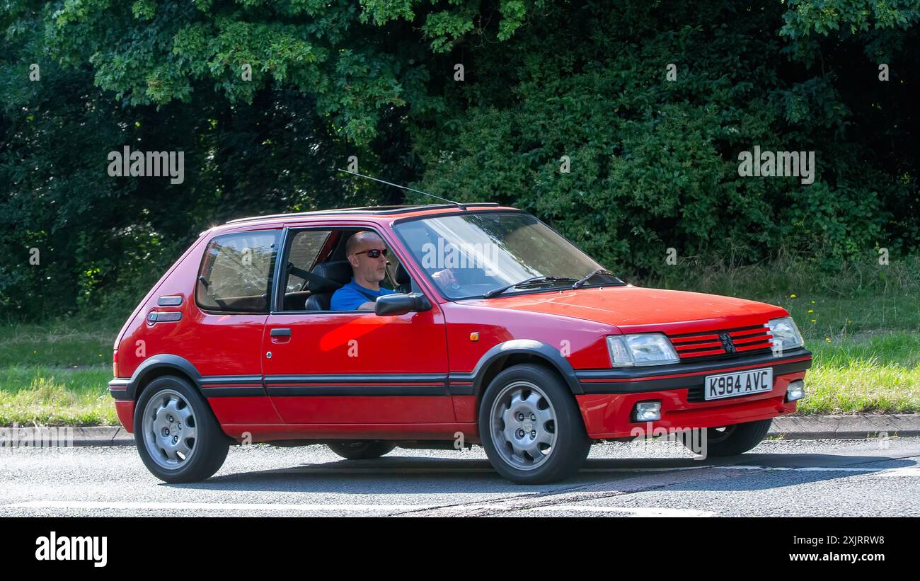 Milton Keynes,UK - July 18th 2024: 1992 red Peugeot 205 car driving on ...