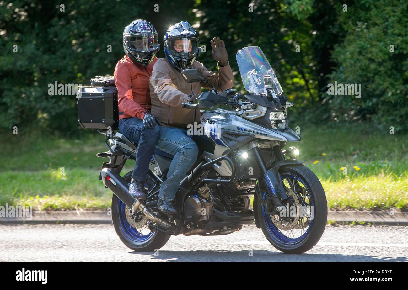 Milton Keynes,UK - July 18th 2024: Man and pillion passenger riding a ...