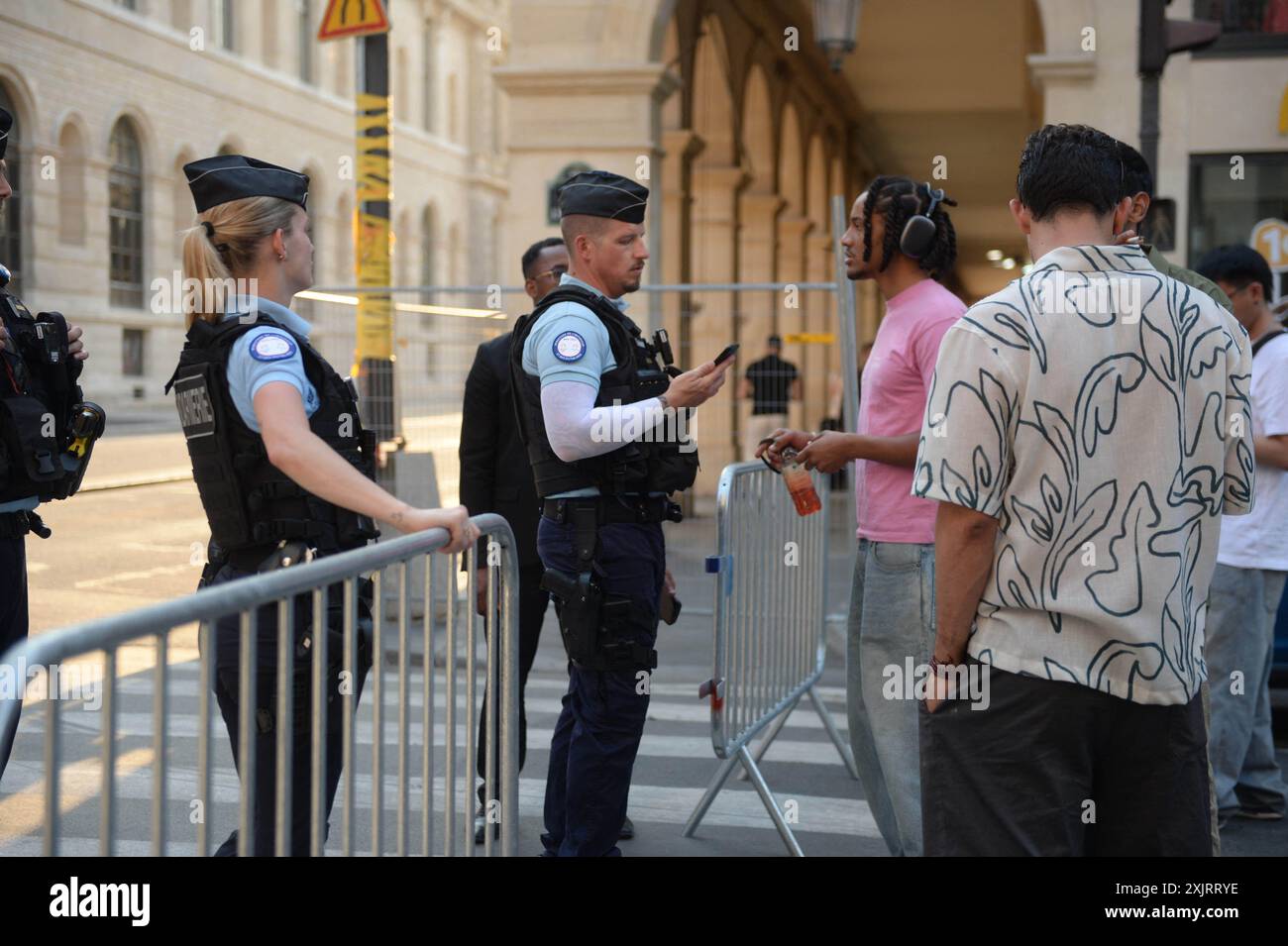 Gendarmerie officers check pedestrians QR codes at a barriers ...