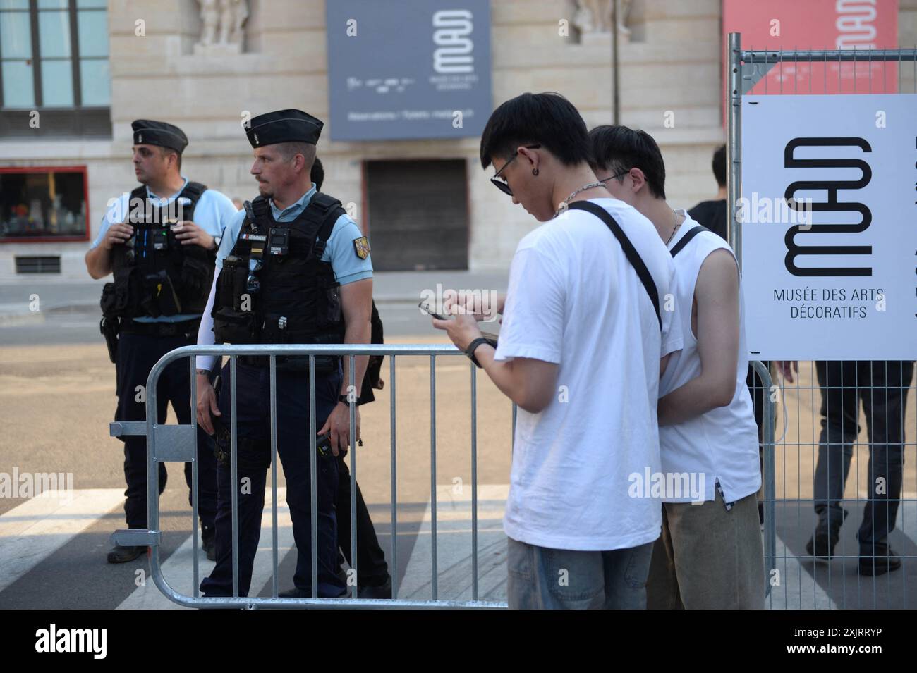 Gendarmerie officers check pedestrians QR codes at a barriers ...